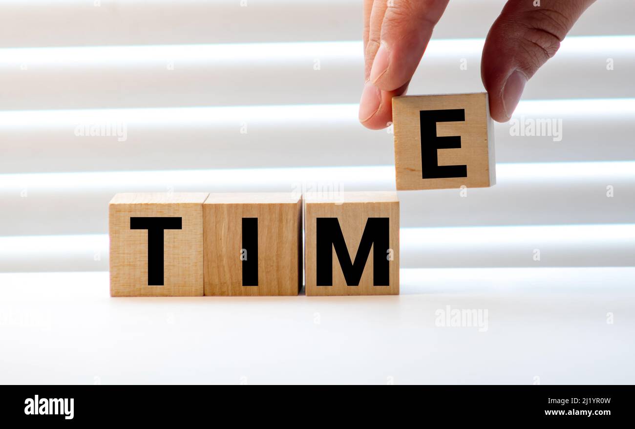 the concept of time. hand men in business suit holding the cubes which ...