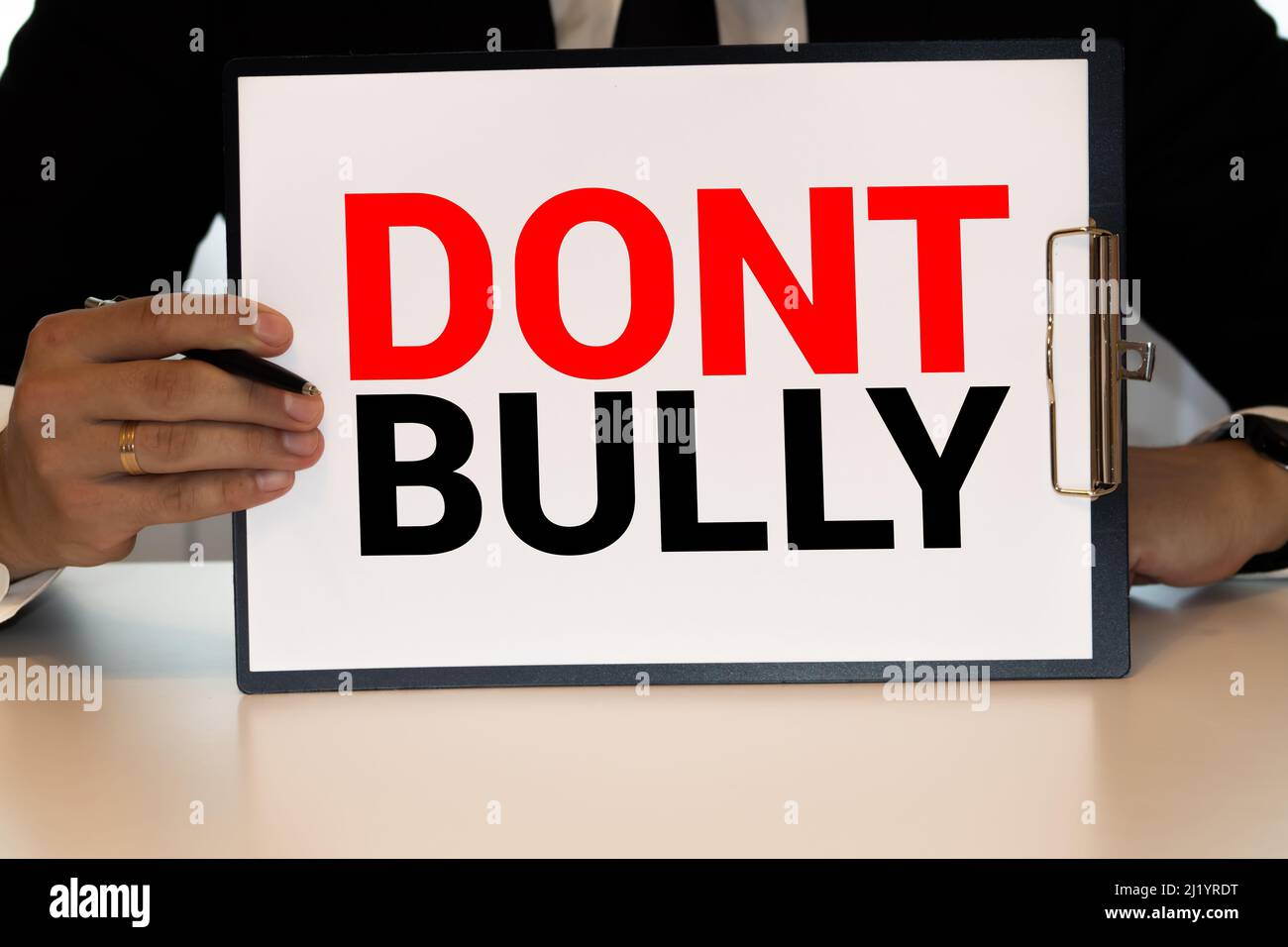 top view of wooden blocks with dont bully lettering on grey background ...