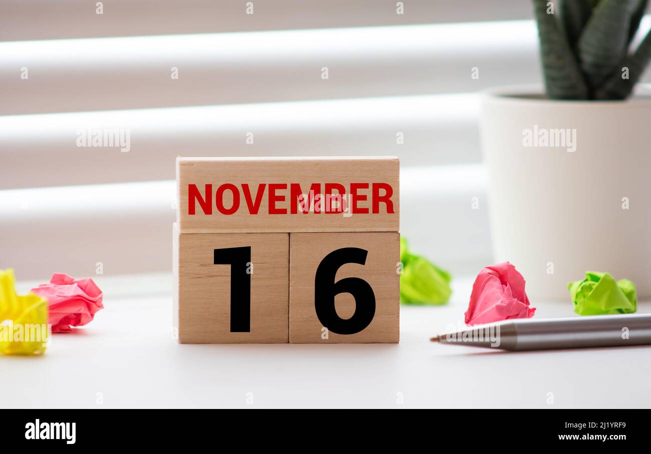 Closeup surface white wooden calendar with black 16 november word on ...