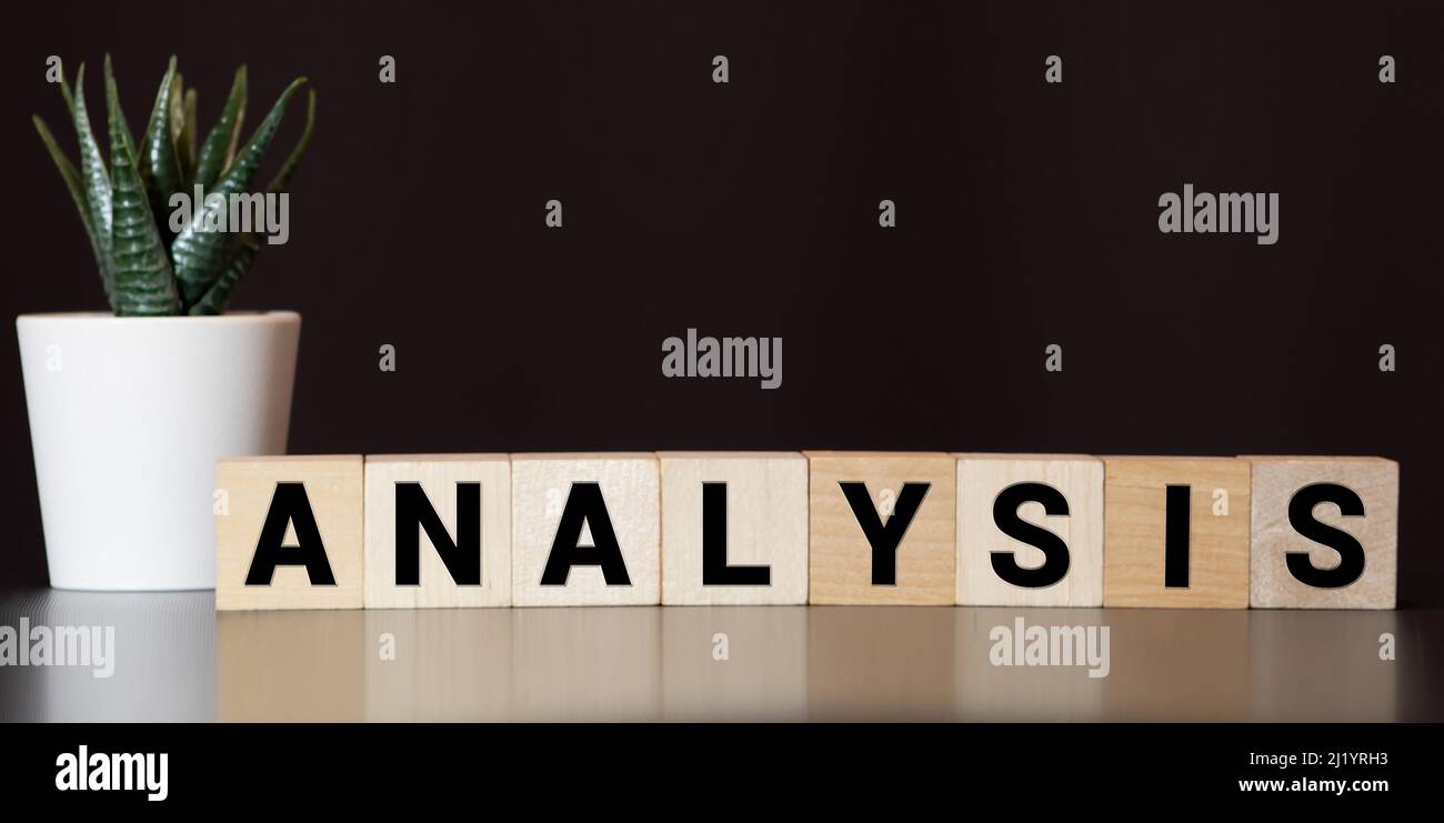 inscription word analysis on wooden cube blocks on a blue background ...