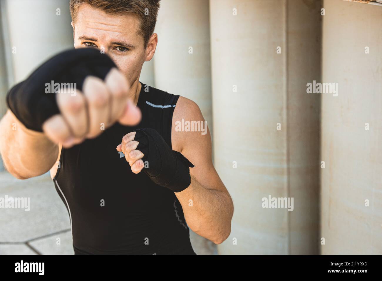 Man exercising and fighting in outside, boxer in gloves. male boxer ...
