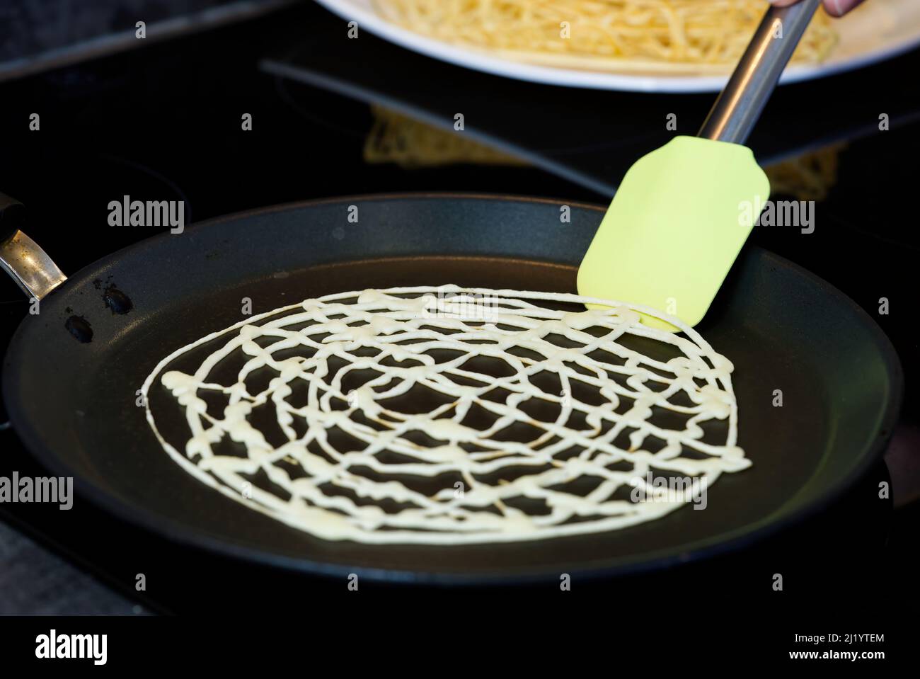 Cooking net pancakes at home. unusual street food. Roti Jala malaysian ...