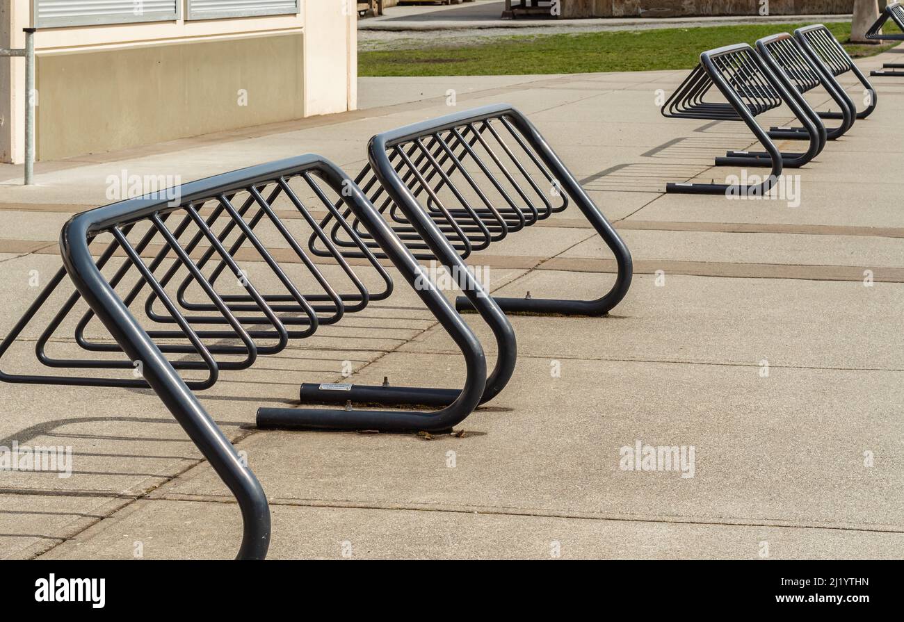 Modern bicycle rack on the street of a city. Nobody, selective focus ...