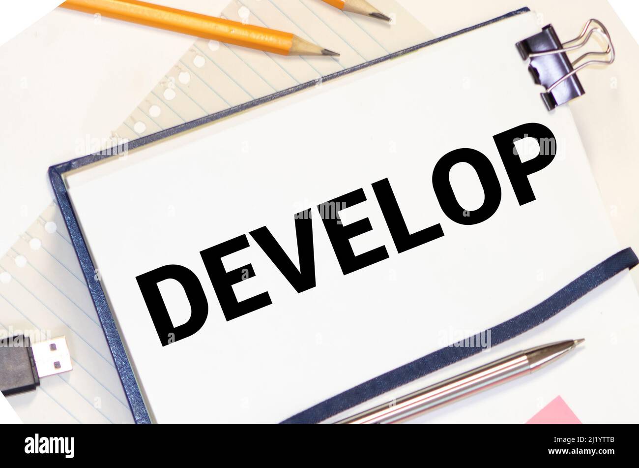 Red pen and notepad with text TRAINING AND DEVELOPMENT in the white ...