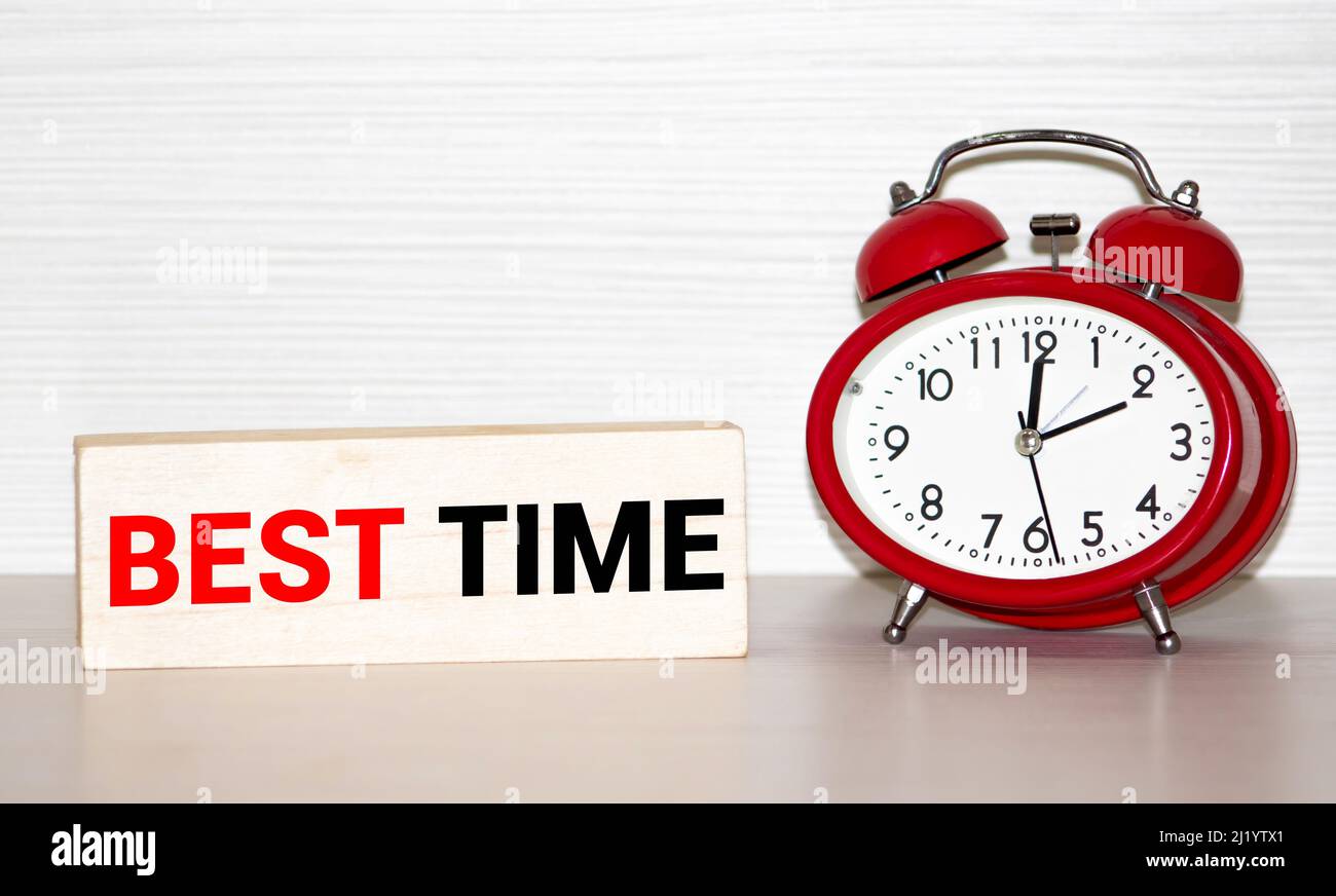 best TIME written in a notebook near a red alarm clock Stock Photo - Alamy