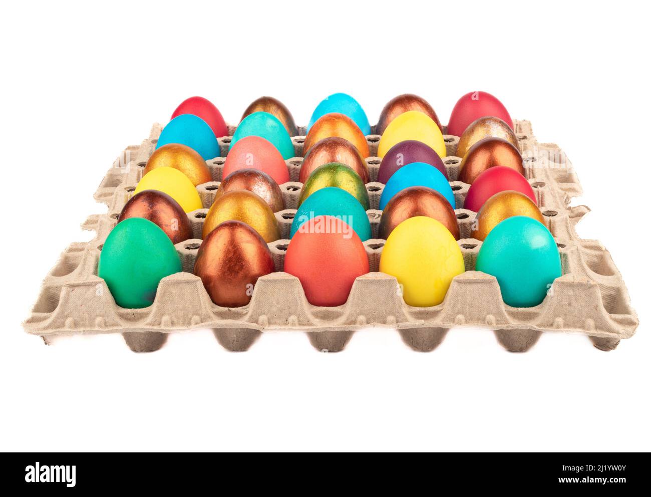 Colored painted eggs on a cardboard box over a white background. Copy ...