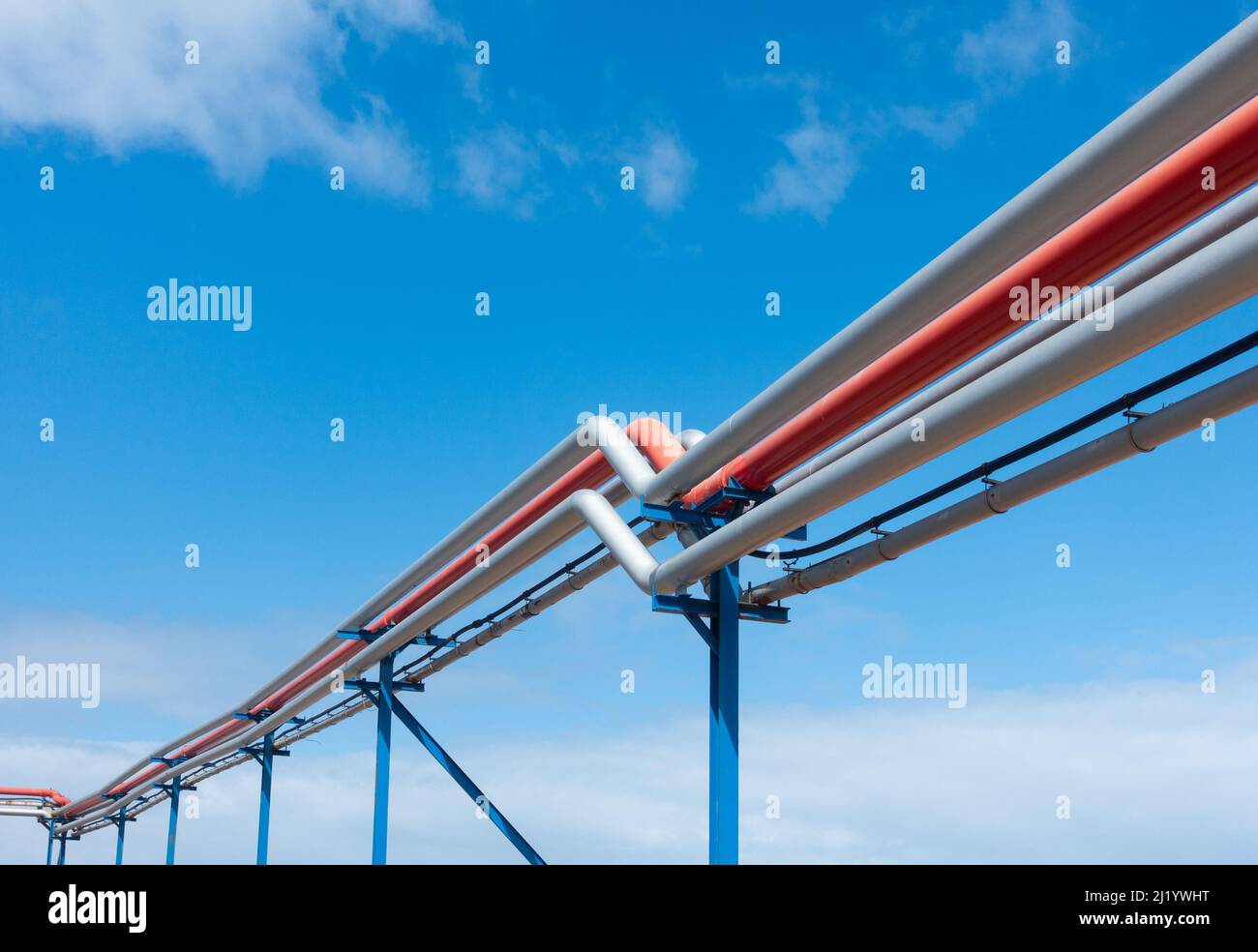 Gas pipeline at refinery against blue sky Stock Photo - Alamy