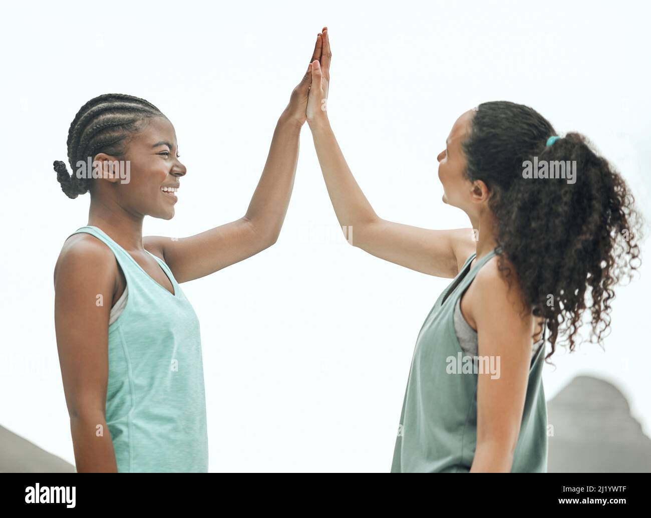 High five for fitness. Shot of two young women giving each other a high ...