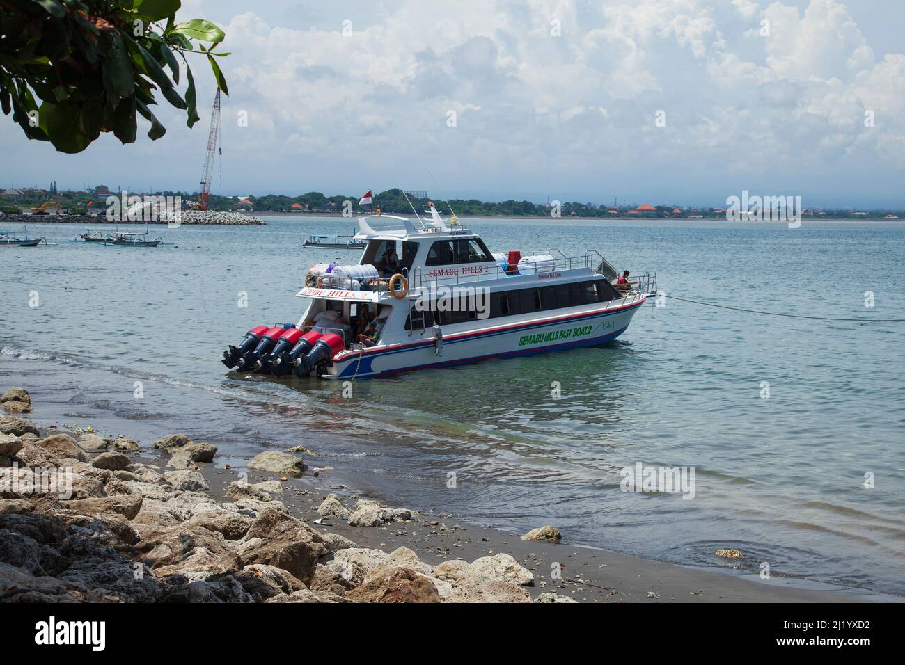 A fast boat with five large outboard engines at Sanur Port waiting to ...