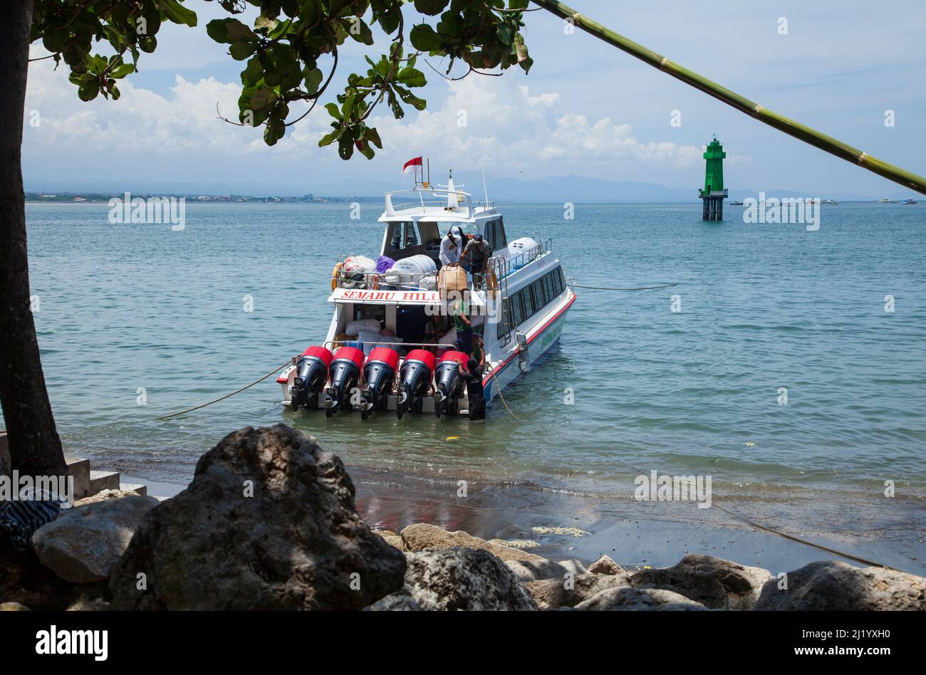 A fast boat with five large outboard engines at Sanur Port waiting to ...