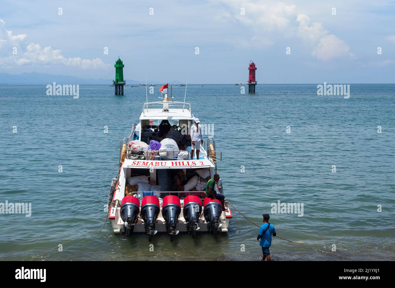 A fast boat with five large outboard engines at Sanur Port waiting to ...