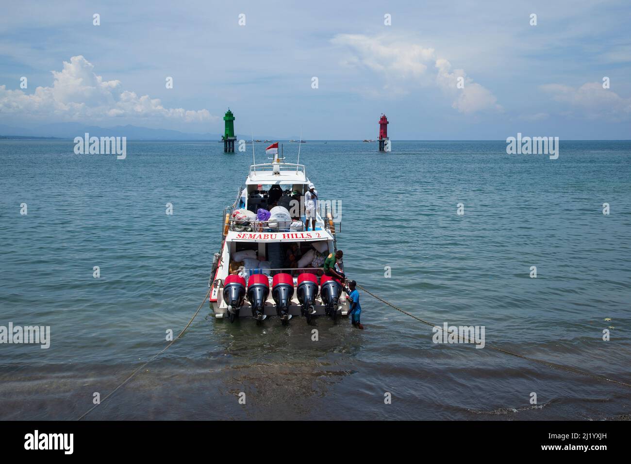 A fast boat with five large outboard engines at Sanur Port waiting to ...