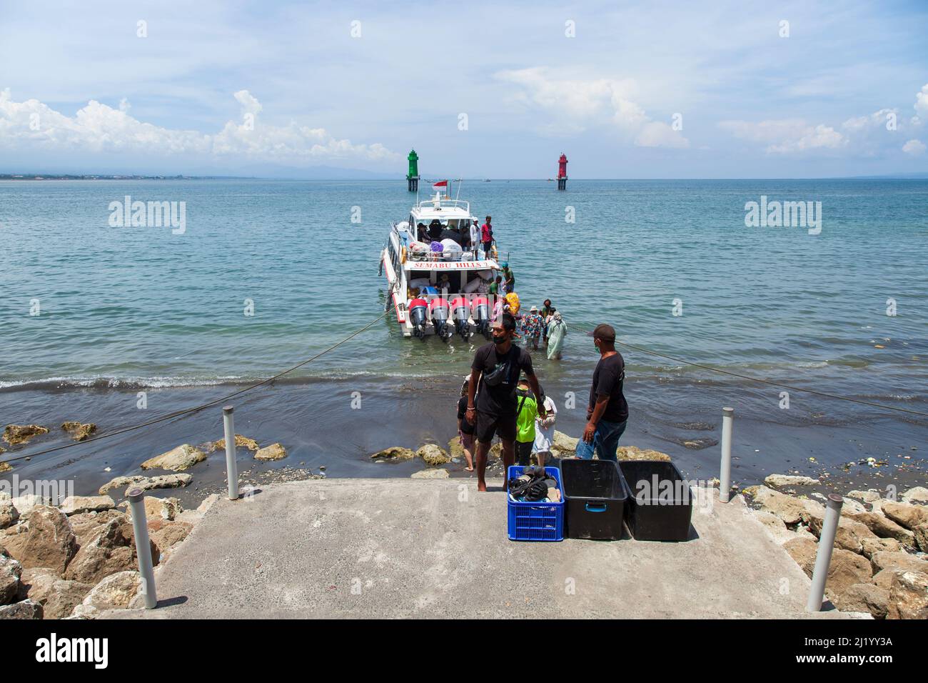 A fast boat with five large outboard engines at Sanur Port waiting to ...