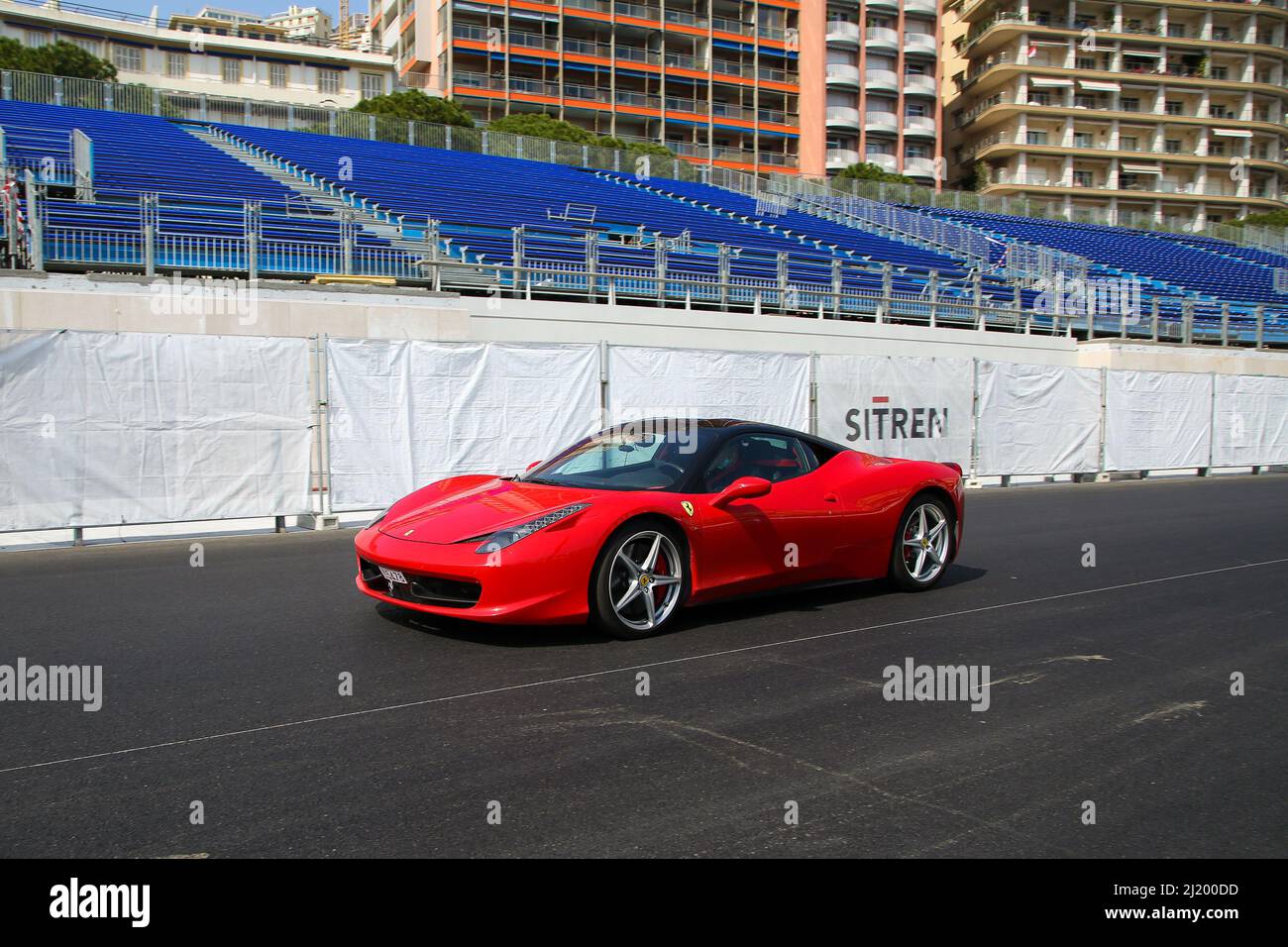 Monte Carlo, Monaco. 28th Mar, 2022. A Ferrari car drives past a stand ...