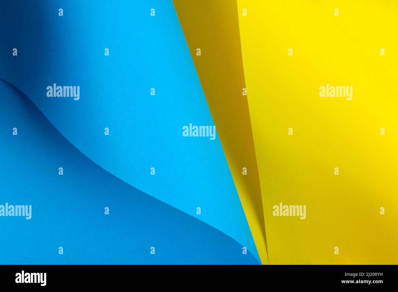 Blue and yellow paper is curved by a wavy line. Background of shape and ...