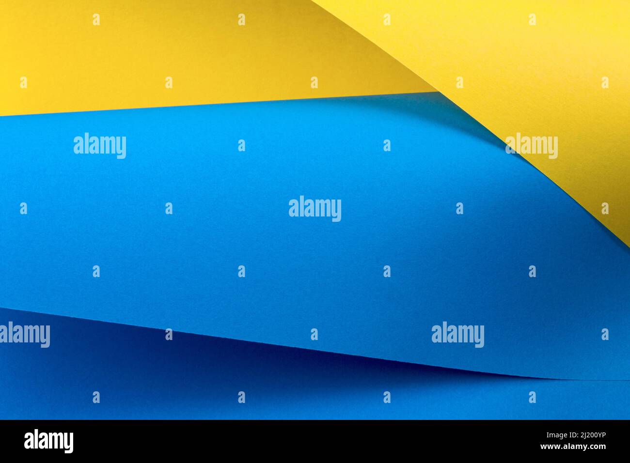 Blue and yellow paper is curved by a wavy line. Background of shape and ...