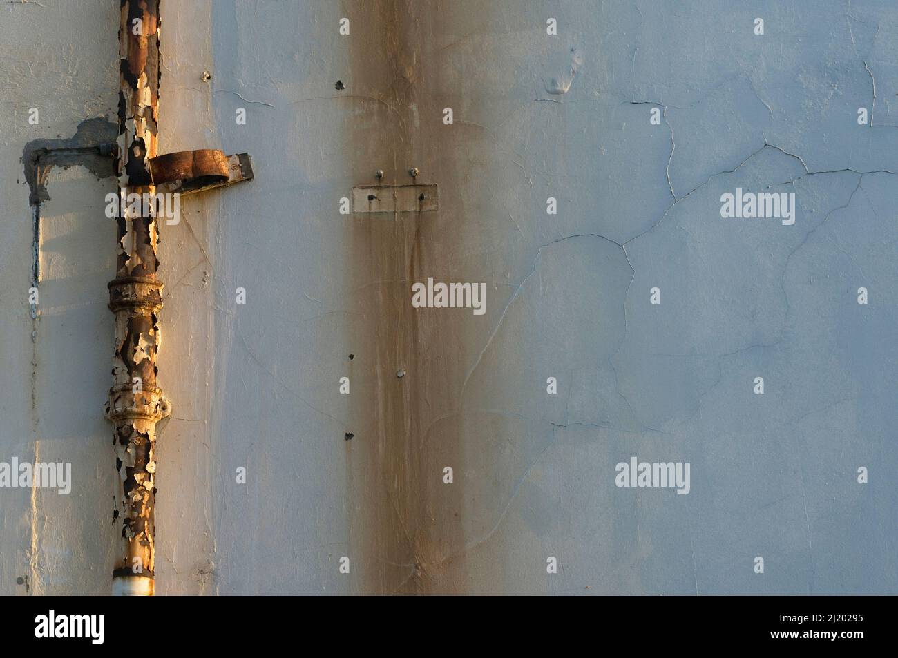 Rusty drain pipe. Rusty drain pipe with paint peeling off is light up ...