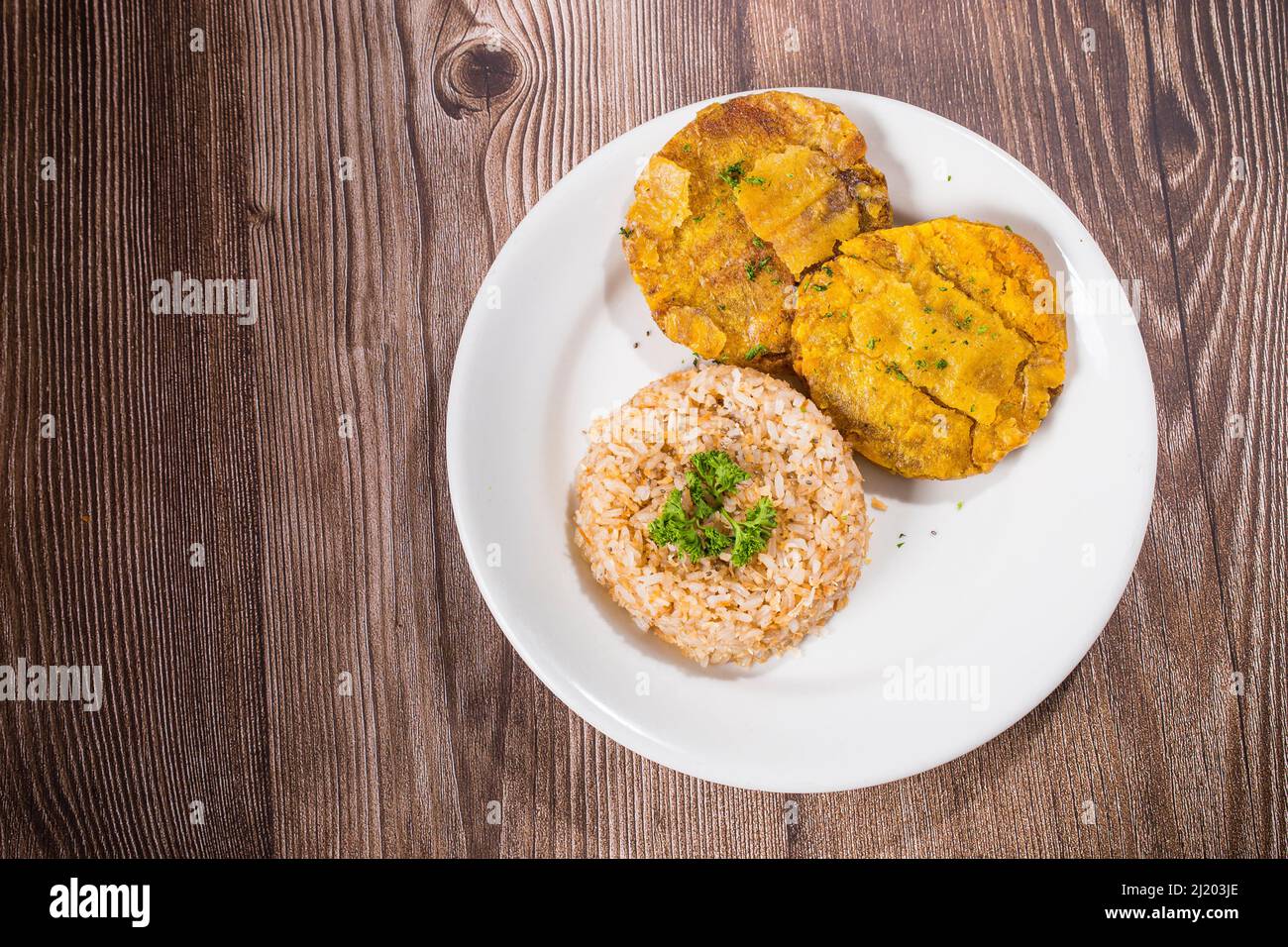 Coconut rice and plantain patacon, rice and patacon in plate on the ...