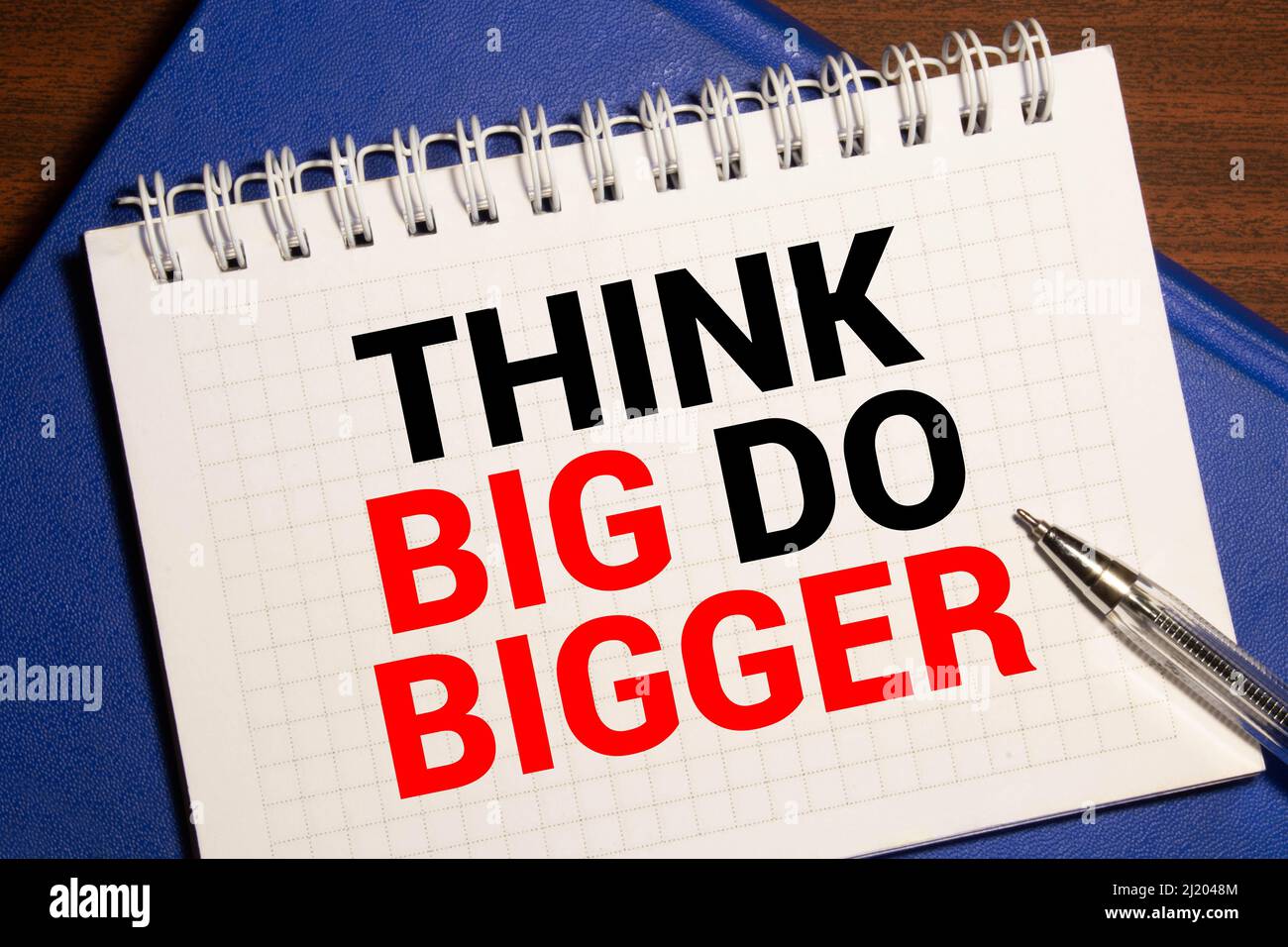 Think Big, Do Bigger Motivation quote notepad writing on dark ...