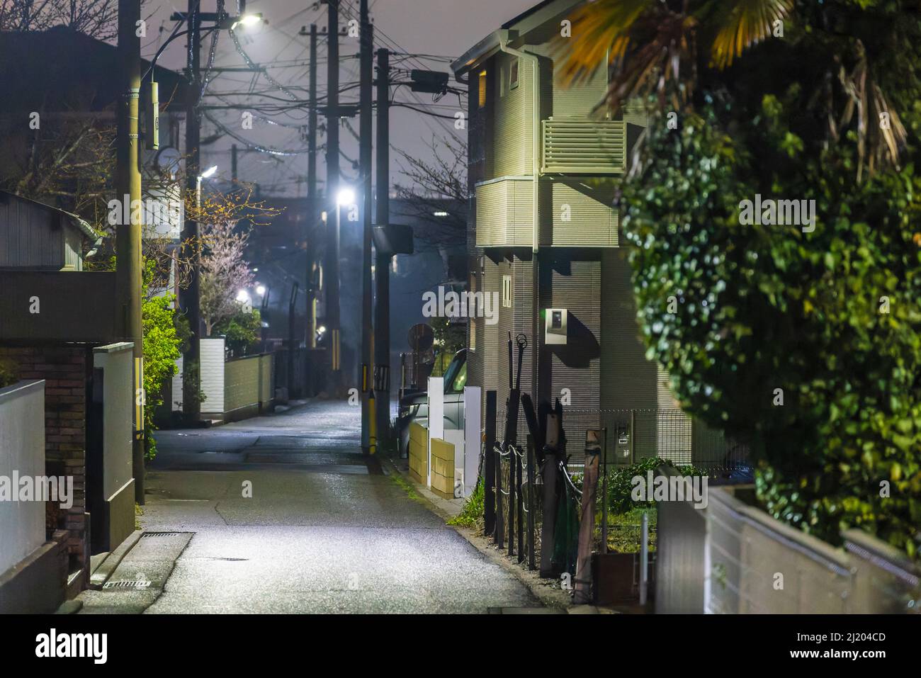 Narrow empty street in quiet Japanese neighborhood at night Stock Photo ...