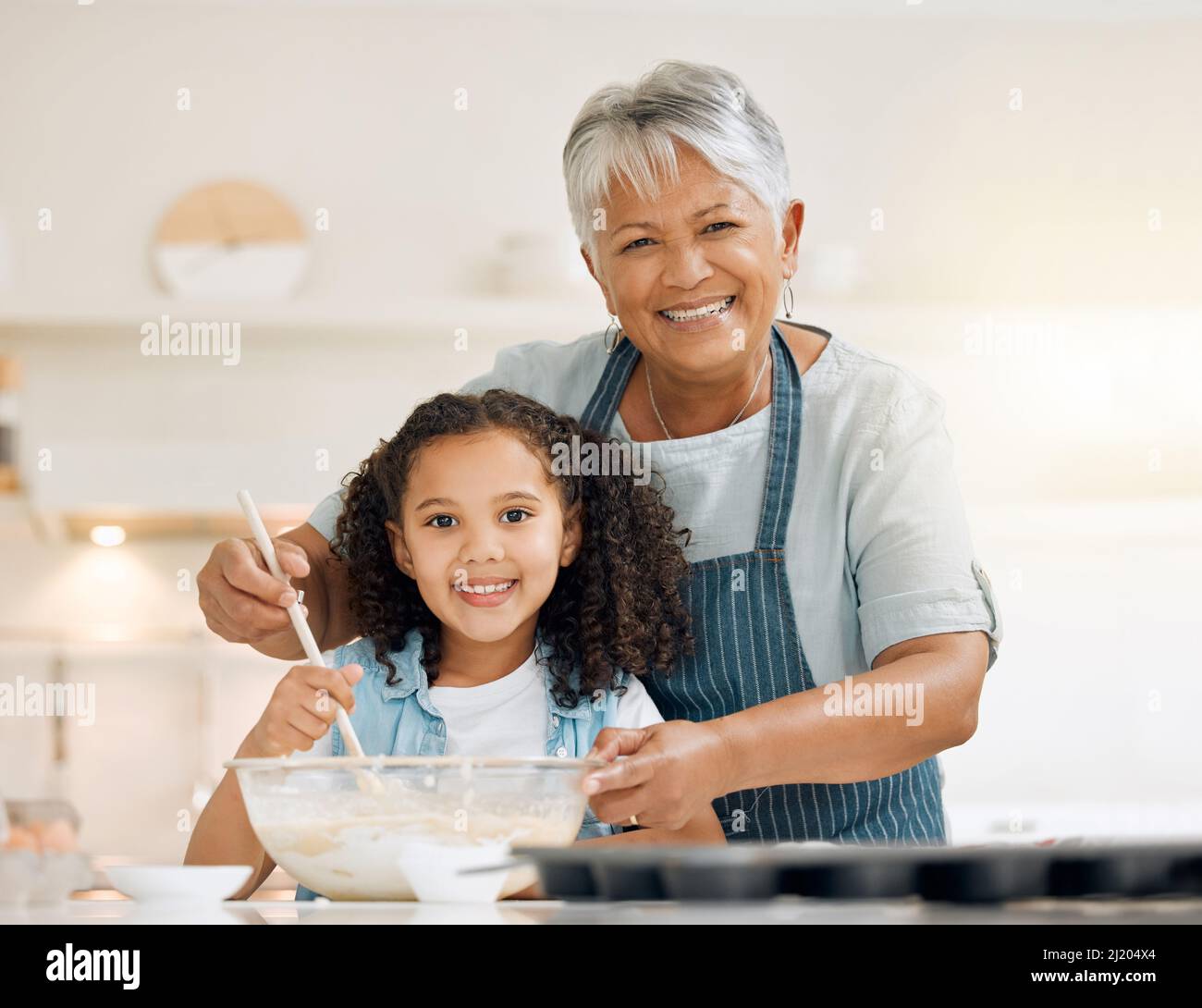 Gran is giving me some baking lessons. Shot of a little girl baking ...