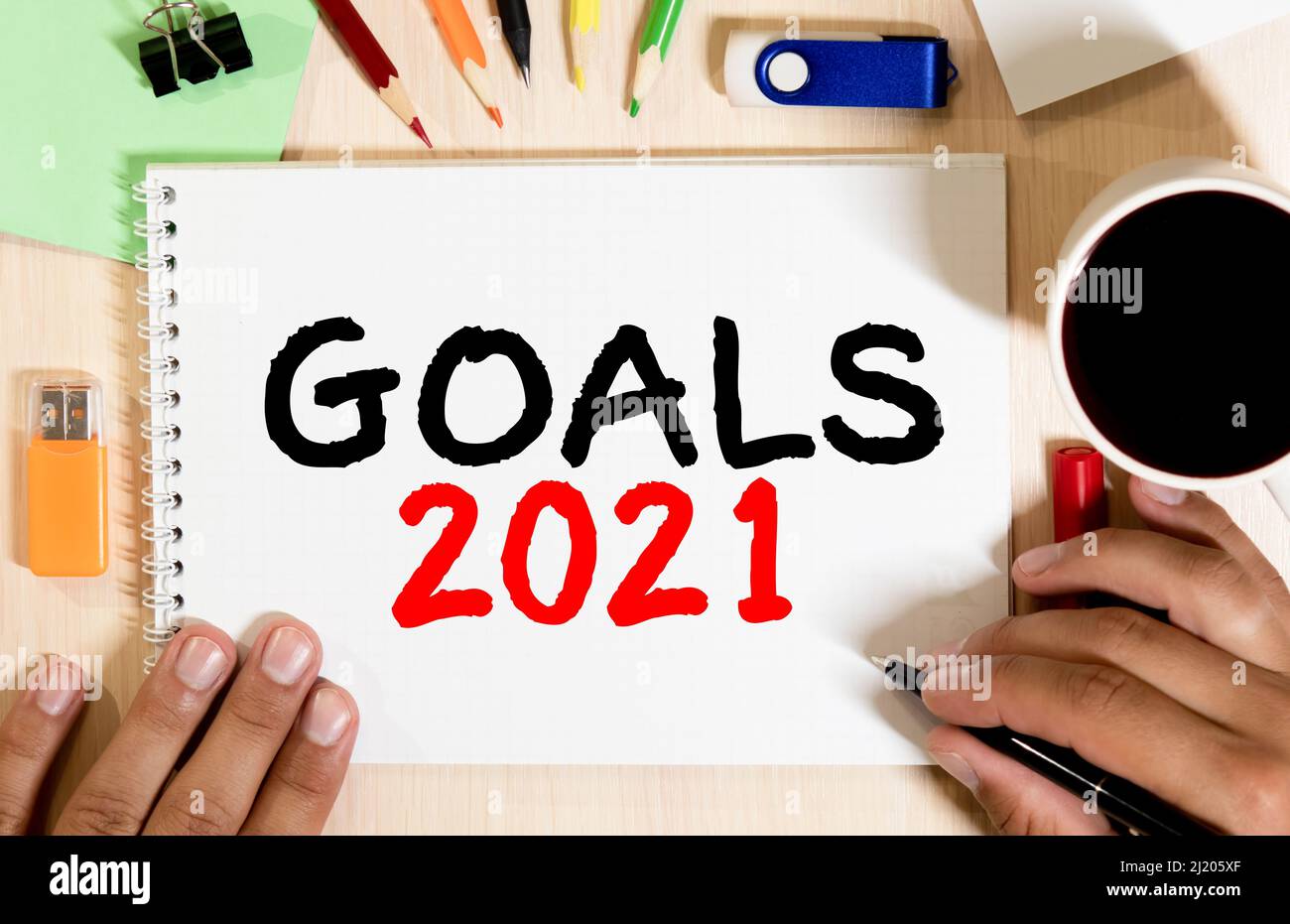 Goals 2021 text on opened notebook on the wood table, goal setting for ...