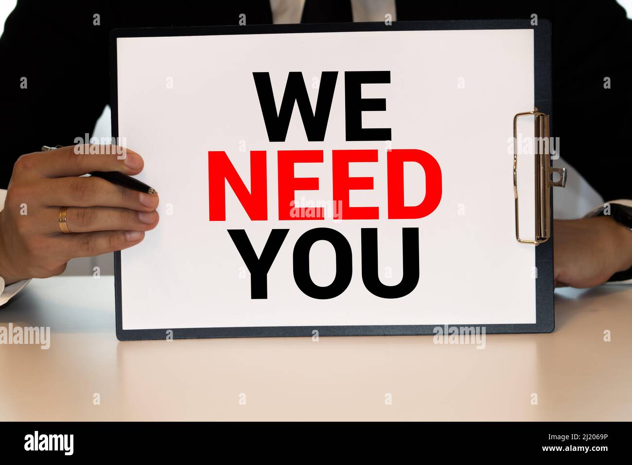 WE NEED YOU. message on the card shown by a man Stock Photo - Alamy