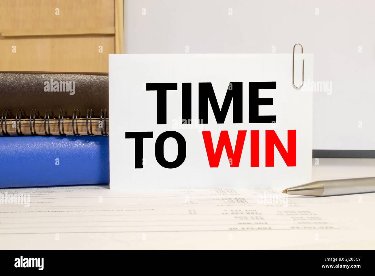 Time to win Blank album paper with time to win inscription on table ...