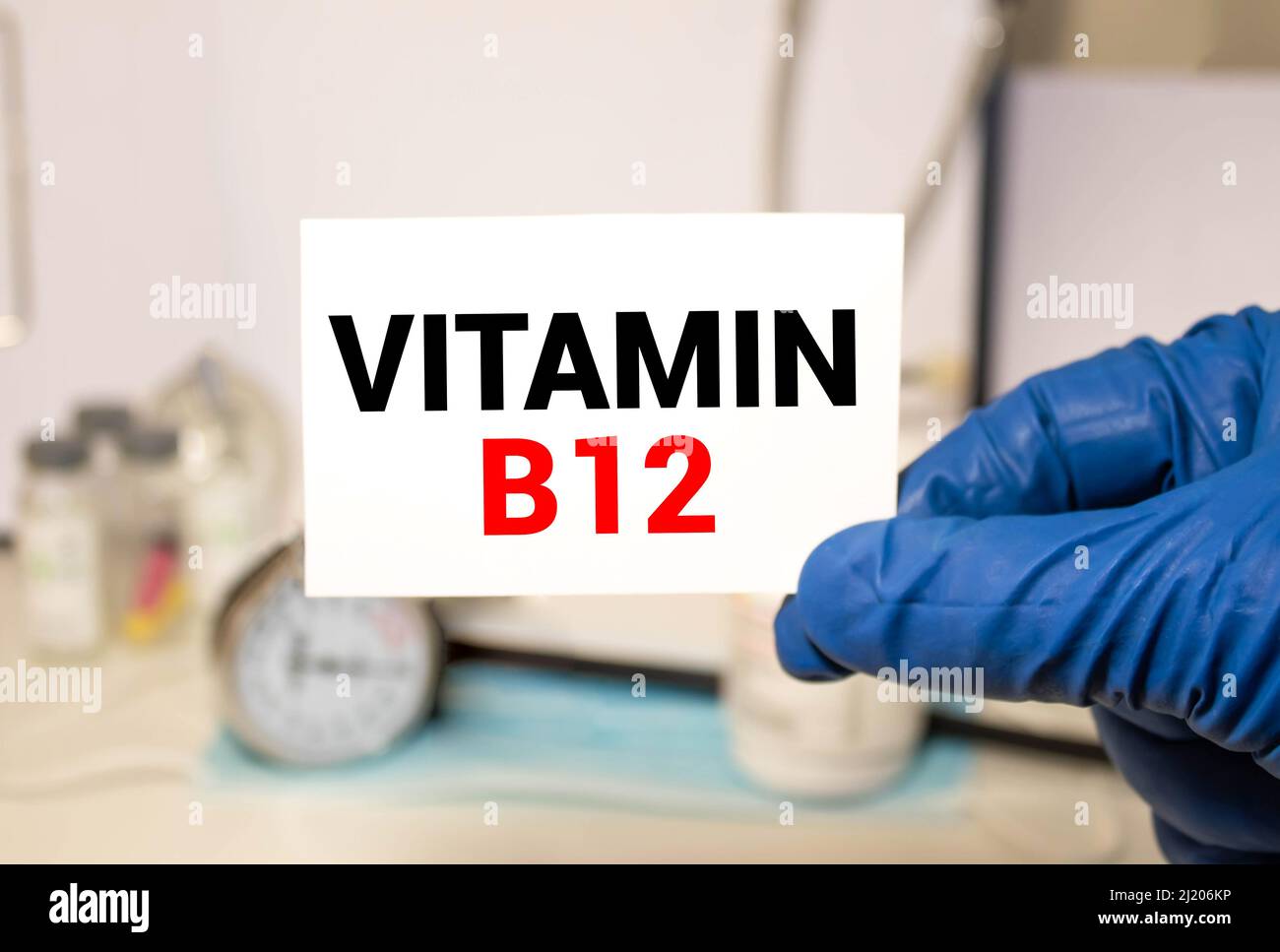 Doctor holding a card with Vitamin B12, medical concept Stock Photo - Alamy
