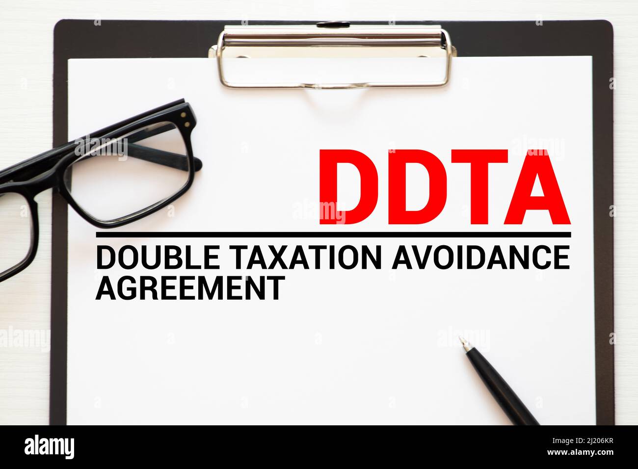 Paper with DTAA Double taxation avoidance agreement on the office table ...