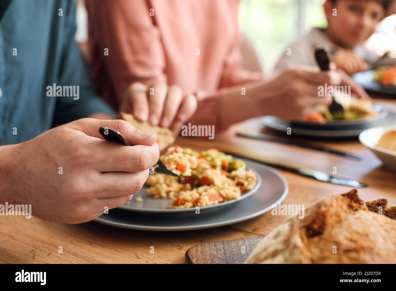 Muslim family having breakfast together, closeup. Celebration of Eid al ...