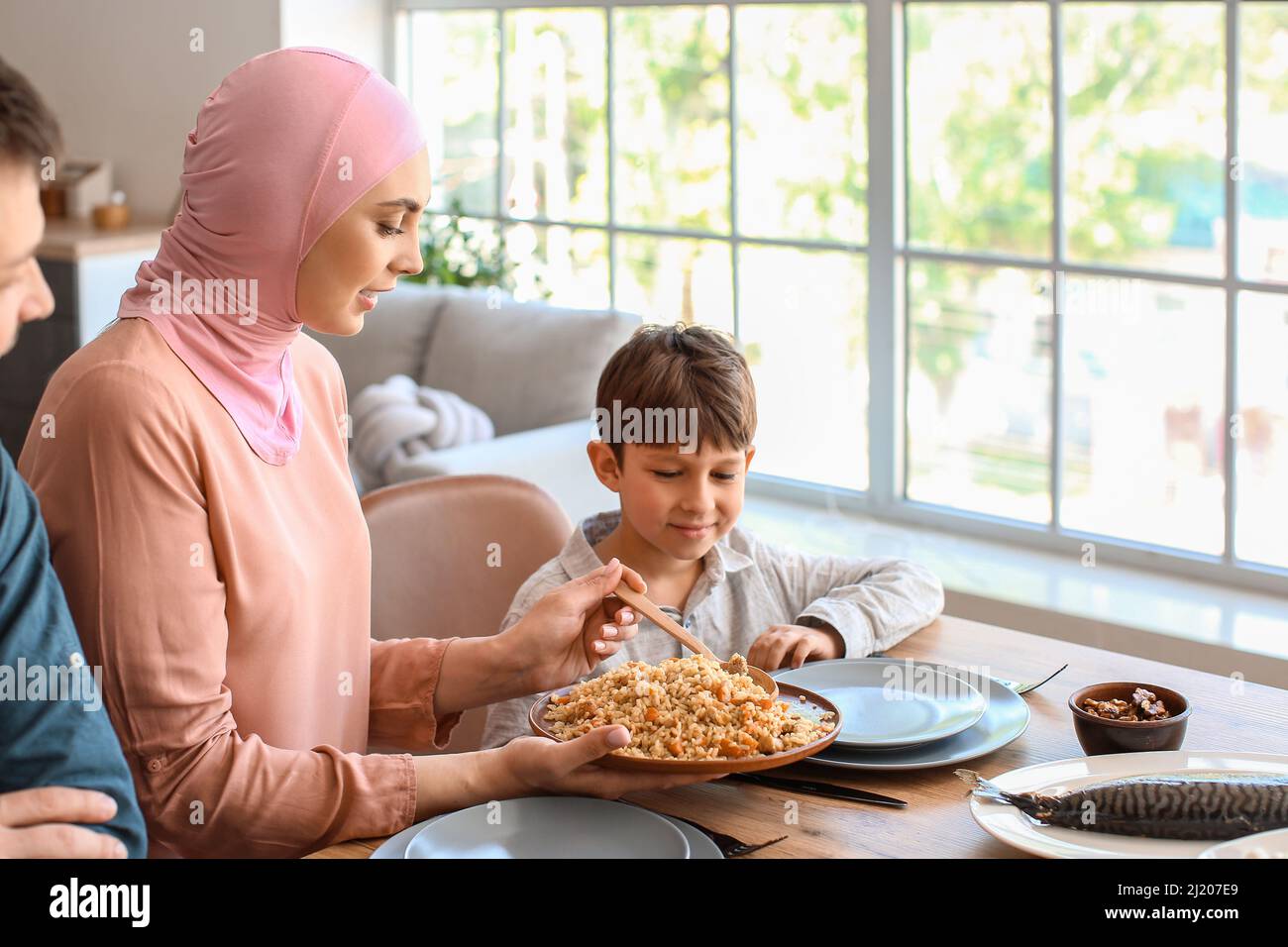 Muslim family having breakfast together. Celebration of Eid al-Fitr ...