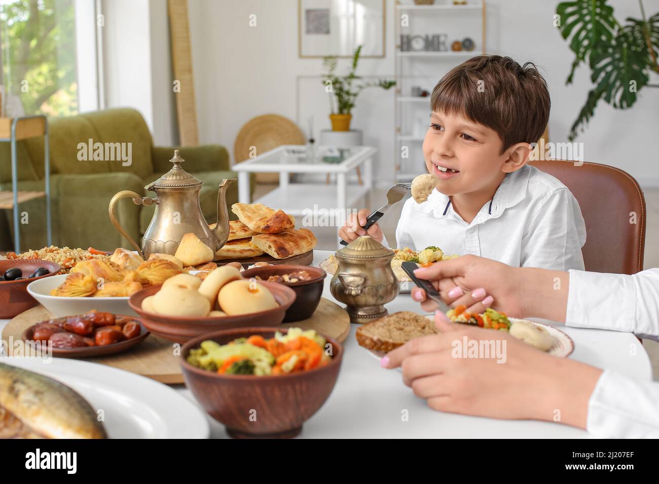 Muslim little boy having breakfast. Celebration of Eid al-Fitr Stock ...