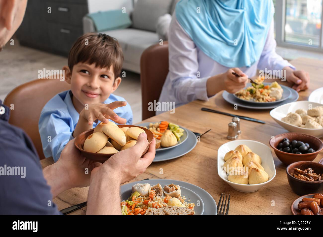 Muslim family having breakfast together. Celebration of Eid al-Fitr ...