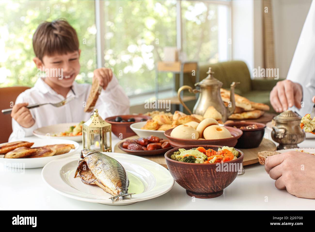 Muslim family having breakfast together. Celebration of Eid al-Fitr ...