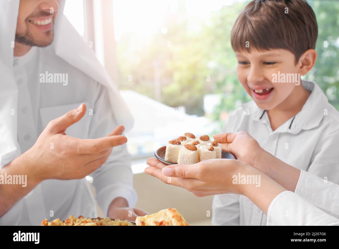 Muslim family having breakfast together. Celebration of Eid al-Fitr ...