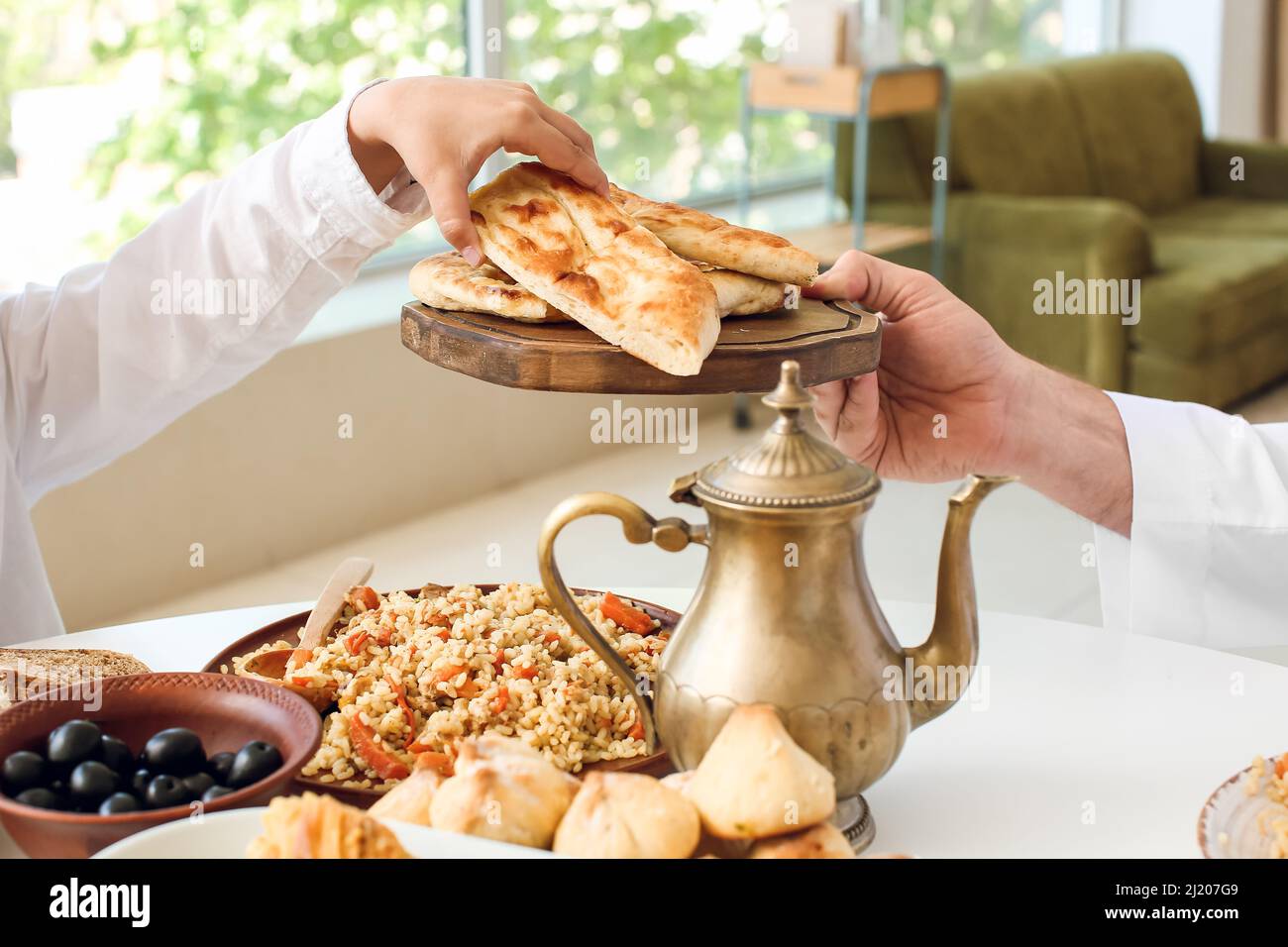 Muslim little boy with his father having breakfast together ...