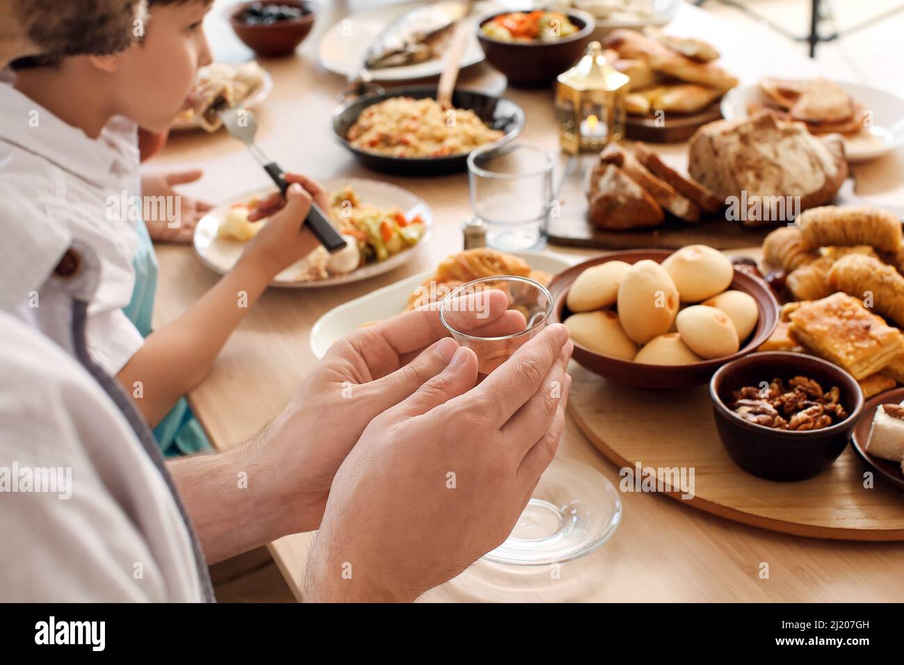 Muslim family having breakfast together. Celebration of Eid al-Fitr ...