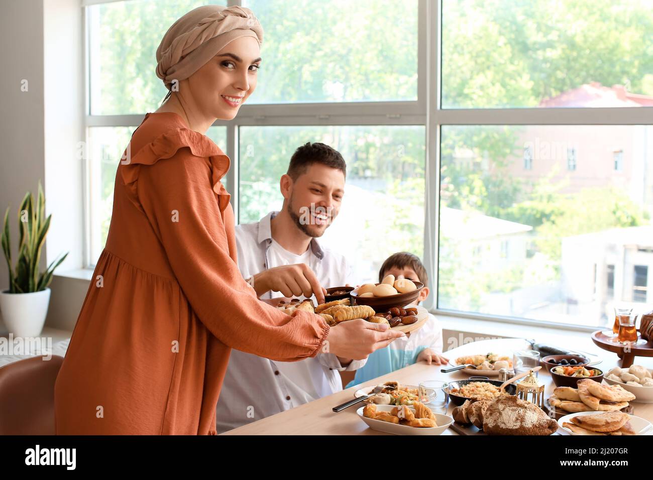 Muslim family having breakfast together. Celebration of Eid al-Fitr ...
