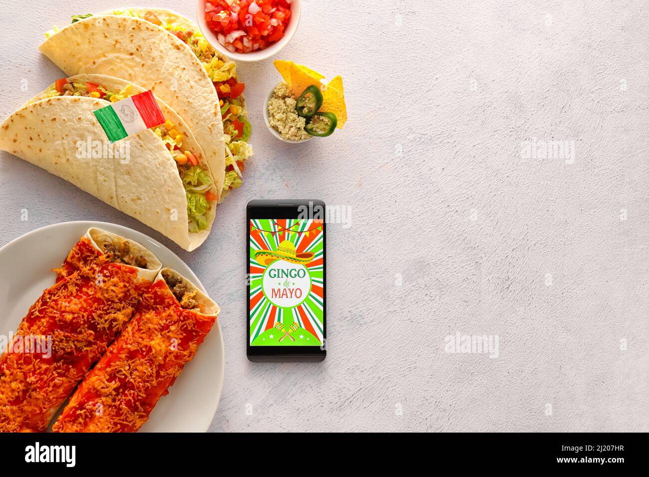 Traditional Mexican food and mobile phone on light background. Cinco de ...