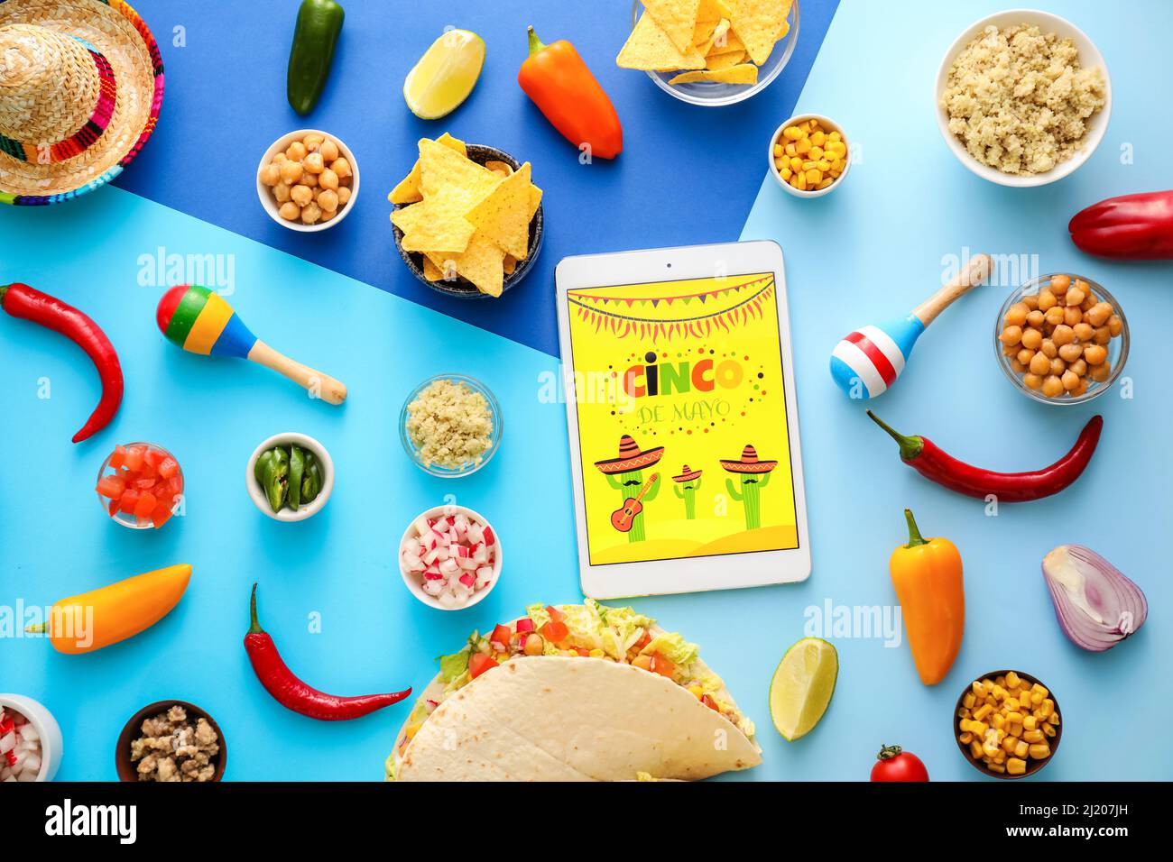 Traditional Mexican food and tablet computer on color background. Cinco ...