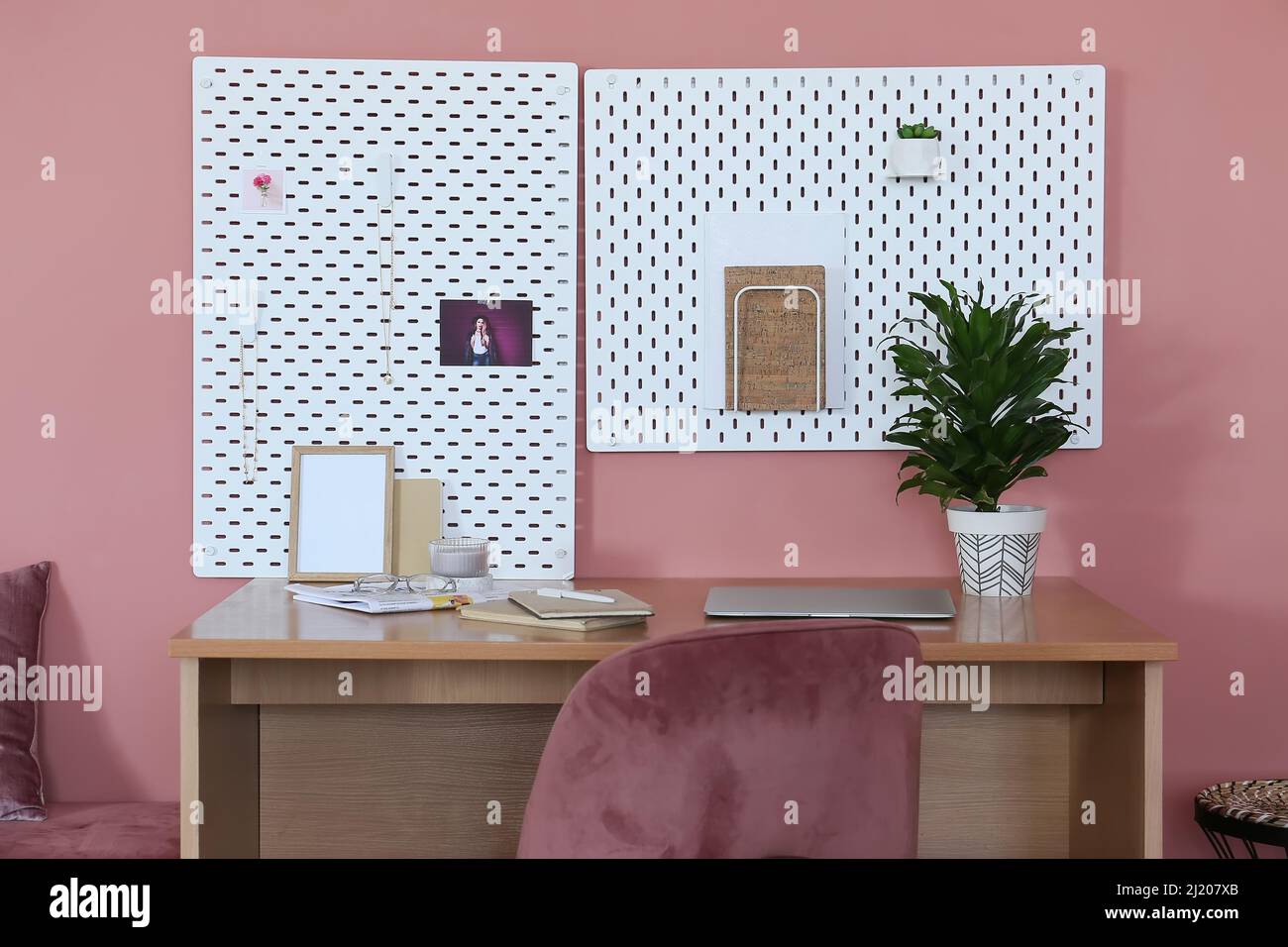 Modern workplace with peg board in interior of room Stock Photo - Alamy