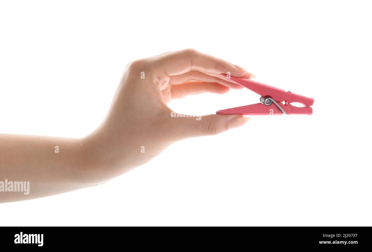 Female hand with plastic clothes pin on white background Stock Photo ...