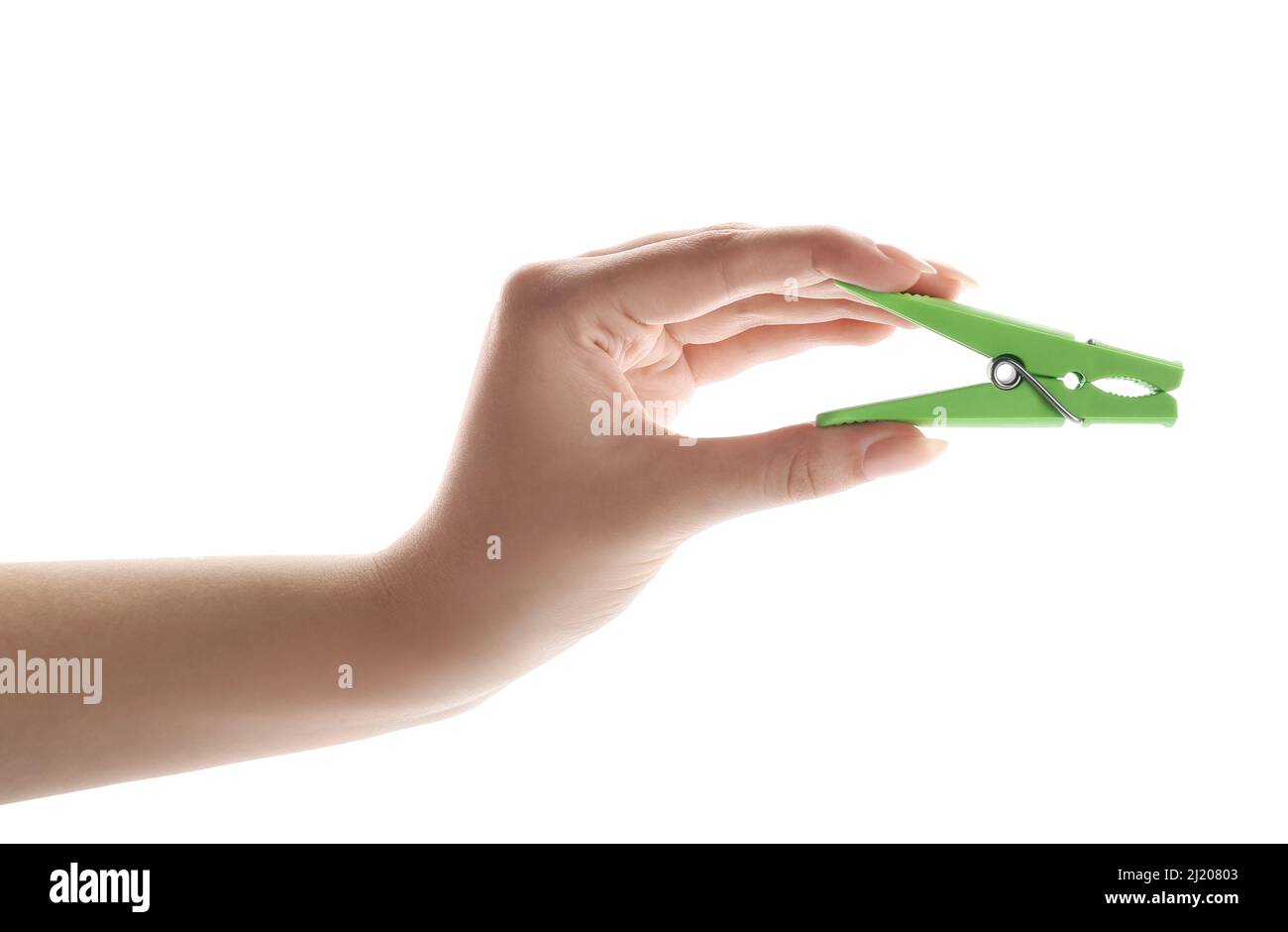 Female hand with plastic clothes pin on white background Stock Photo ...