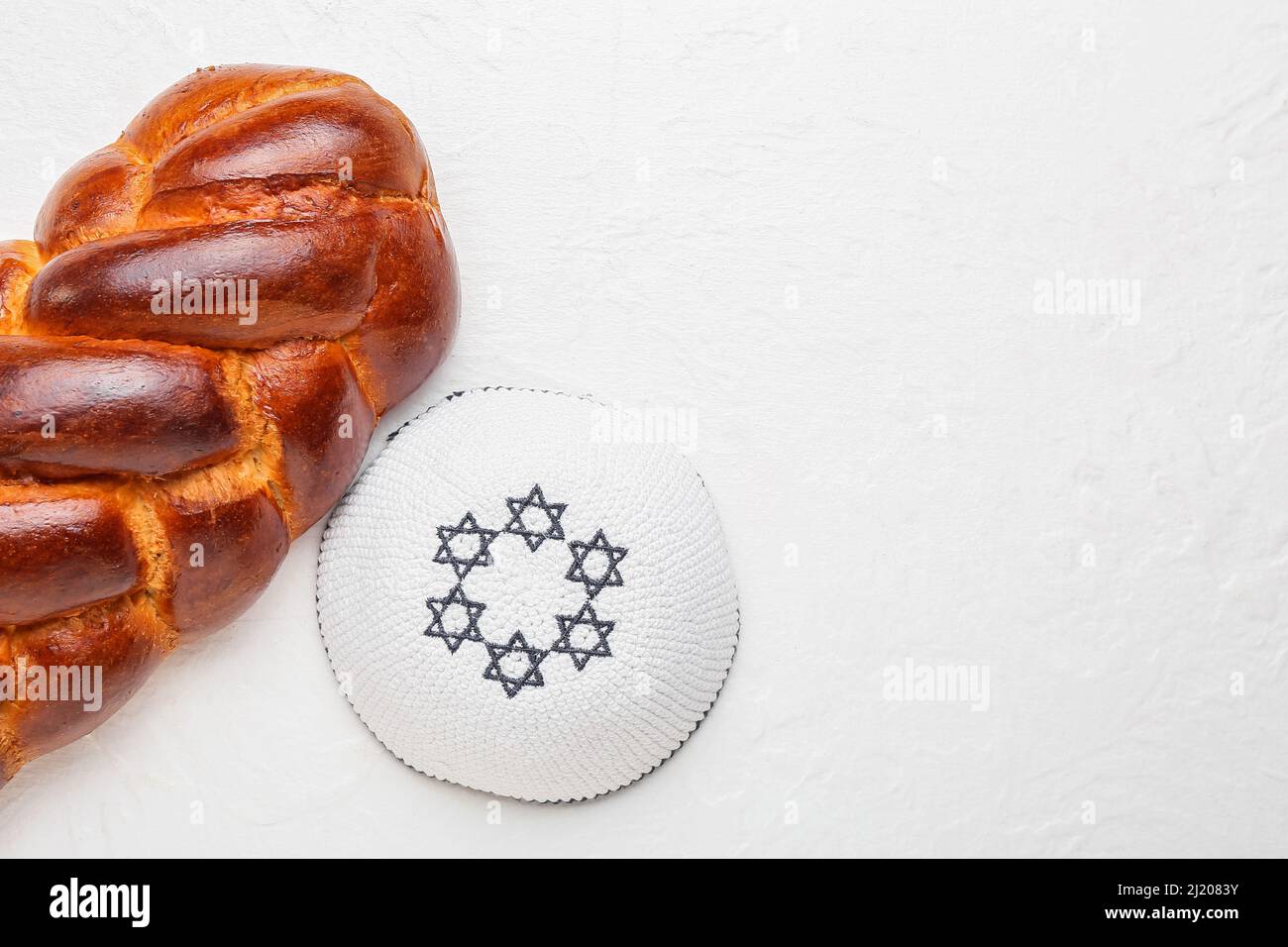 Traditional challah bread with Jewish cap on white background. Shabbat ...