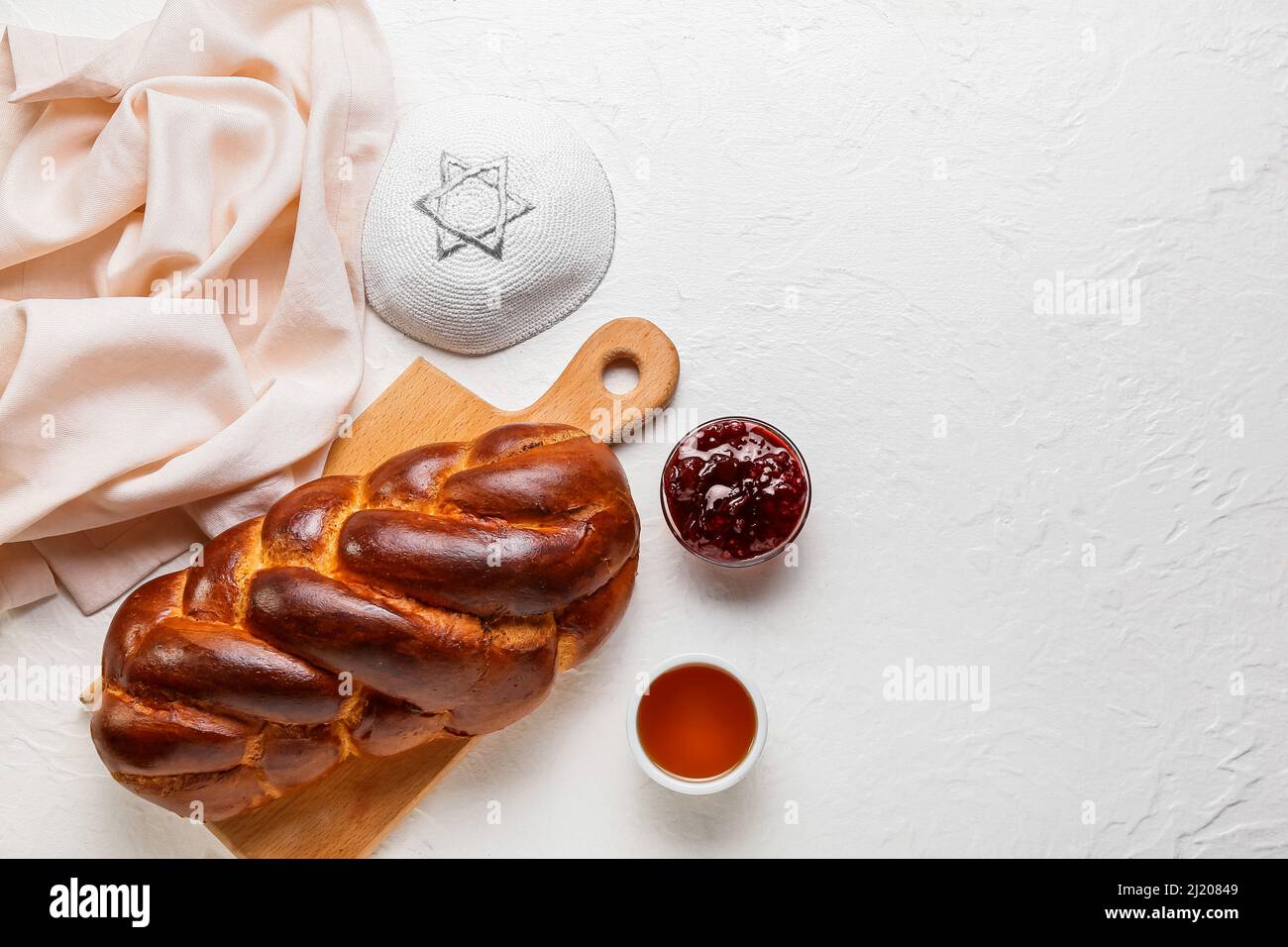 Traditional challah bread with Jewish cap on white background. Shabbat ...
