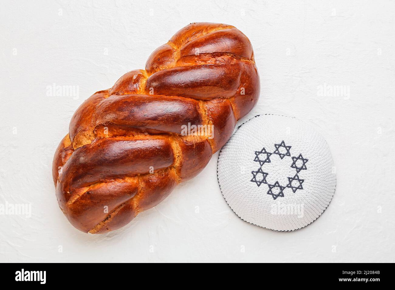 Traditional challah bread with Jewish cap on white background. Shabbat ...
