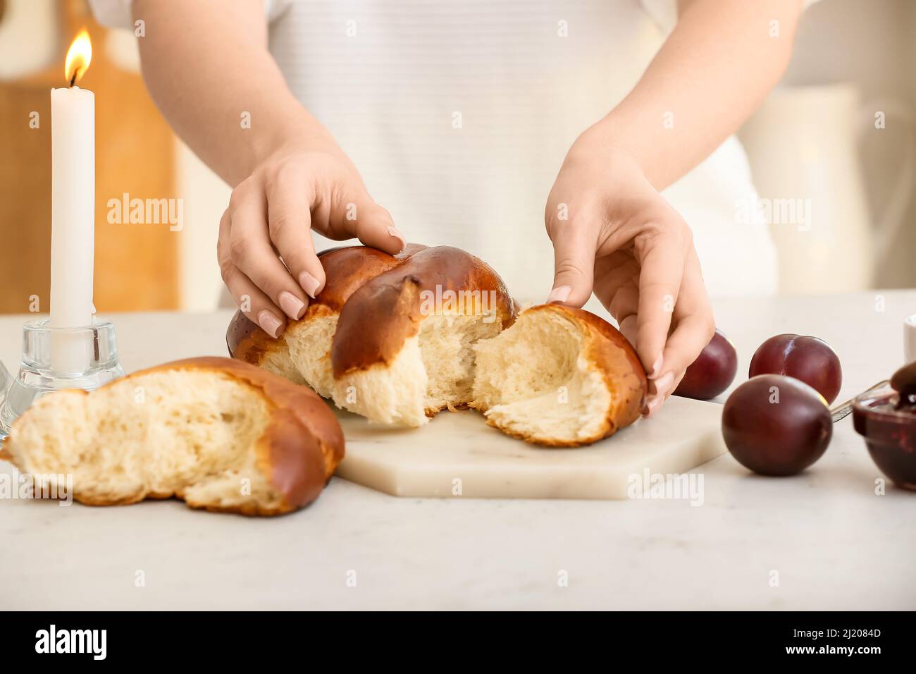 Woman breaking bread on hi-res stock photography and images - Alamy