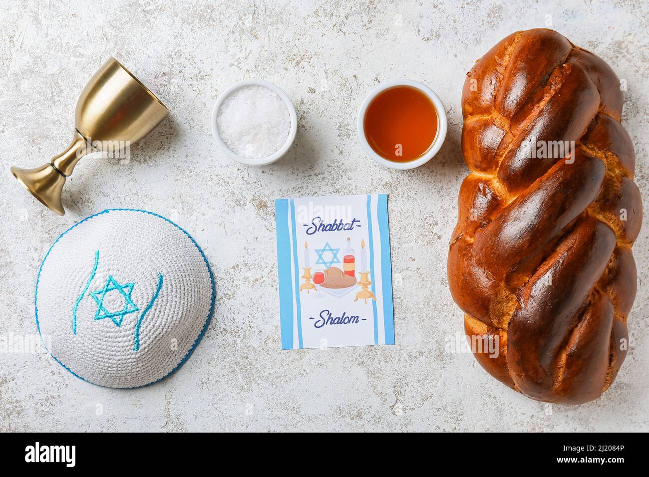 Traditional challah bread with greeting card and Jewish cap on grunge ...