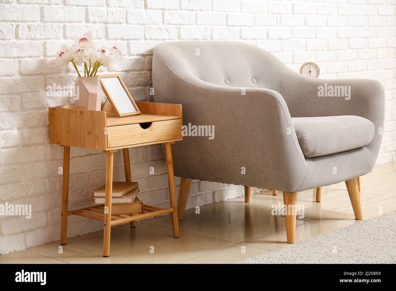 Modern interior of room with table and armchair Stock Photo - Alamy